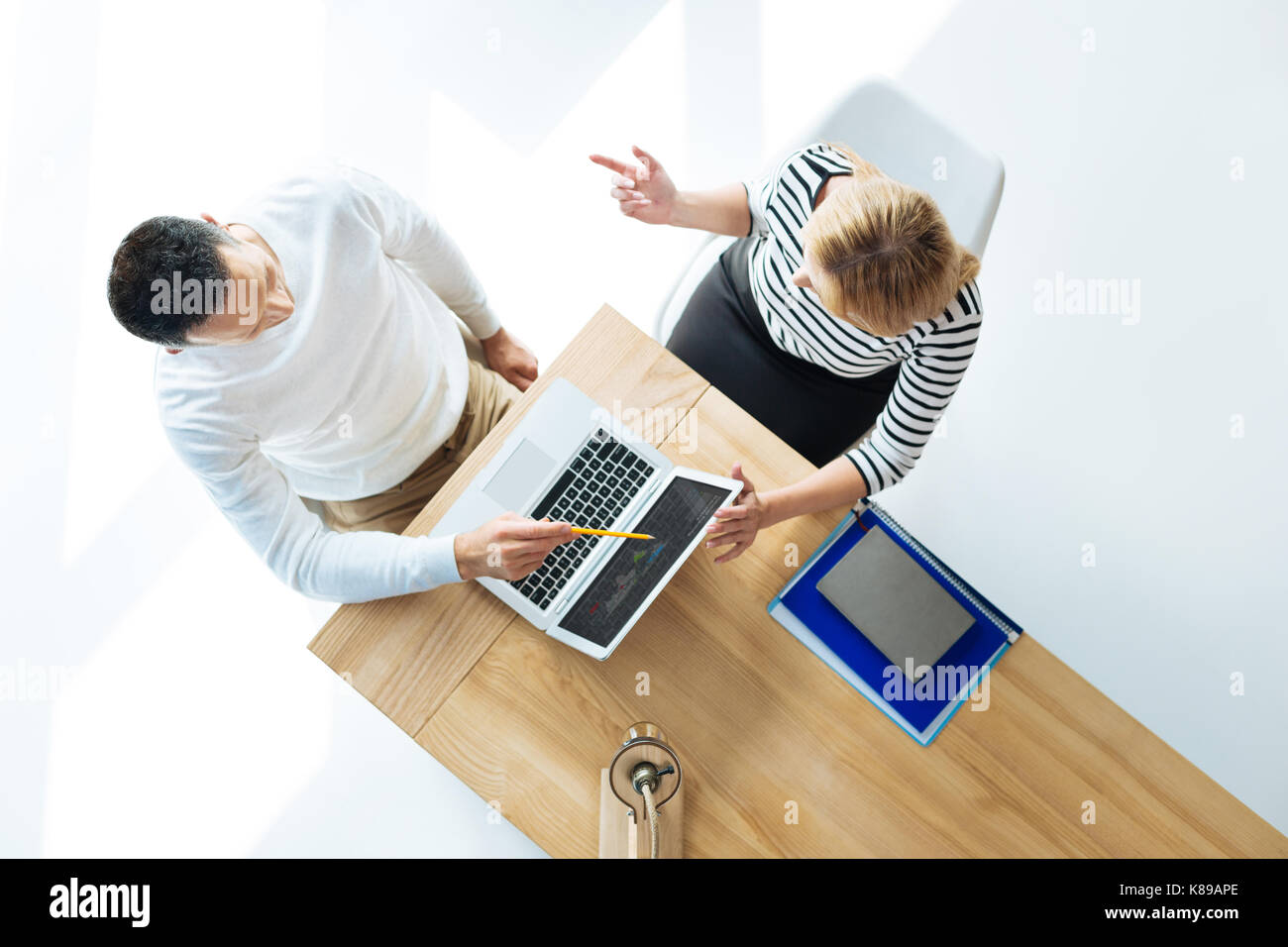 Top view of smart nice colleagues discussing work Stock Photo - Alamy