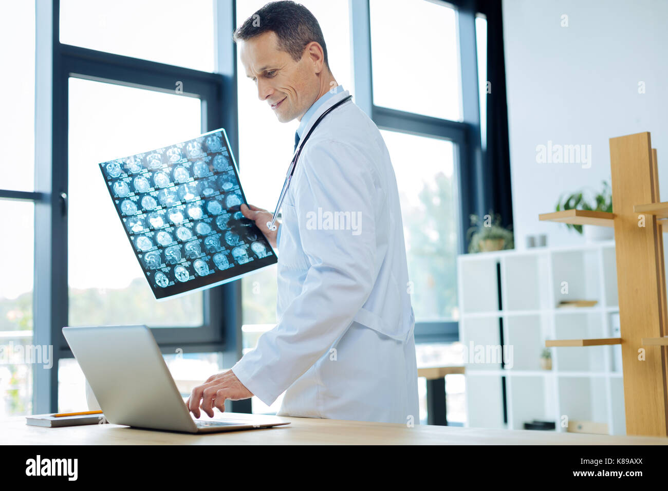 Serious smart radiologist holding an X ray scan Stock Photo - Alamy