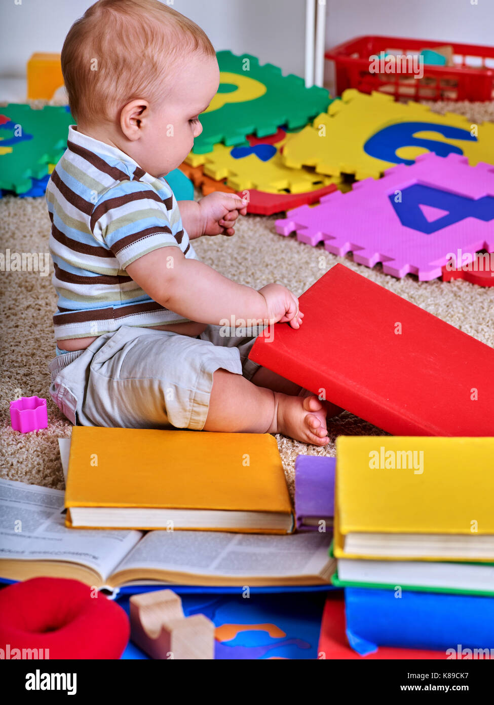 Child jigsaw develops children. Kid puzzle making baby Stock Photo - Alamy