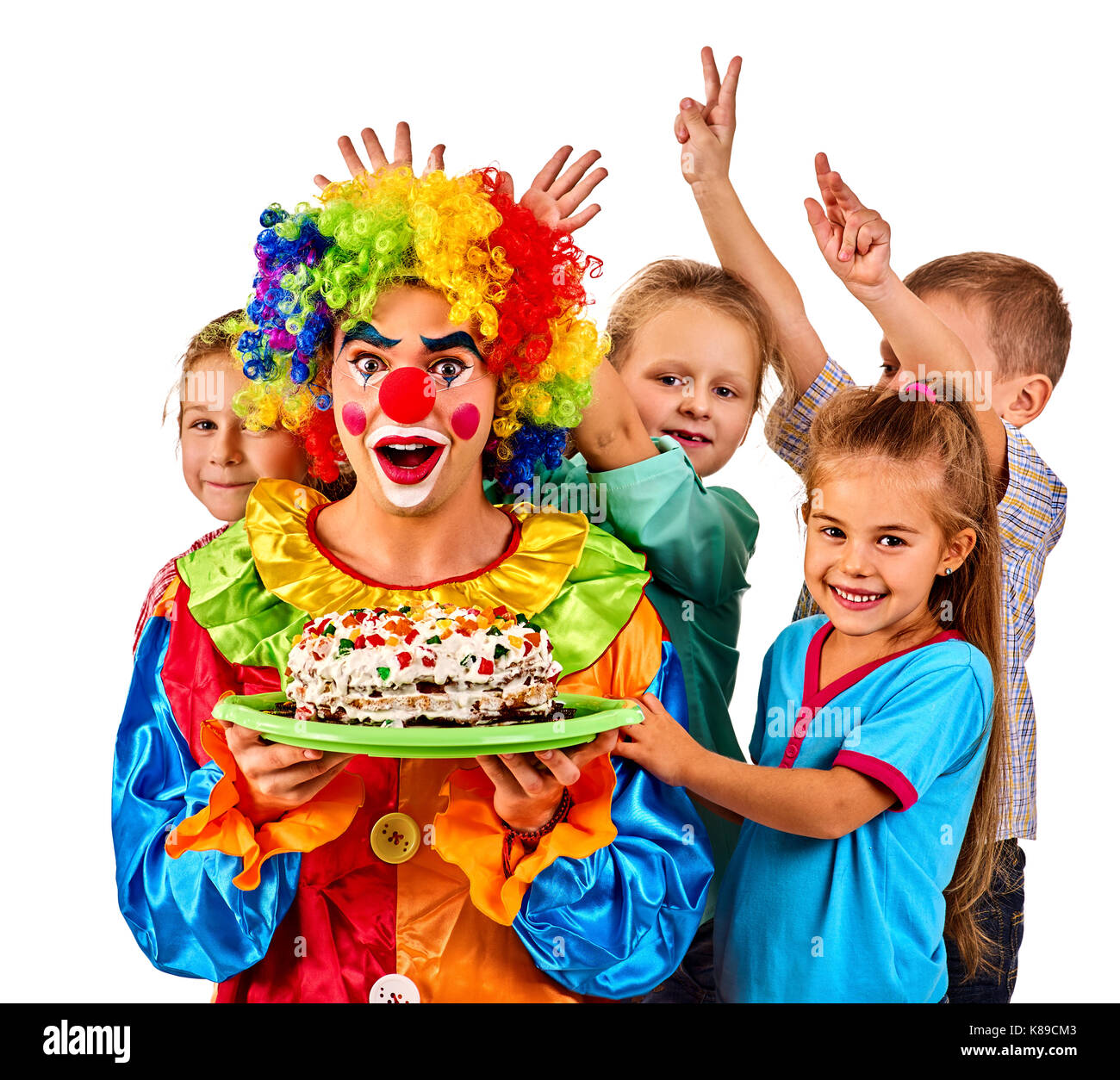 Birthday child clown eating cake with boy together. Kid with messy face ...
