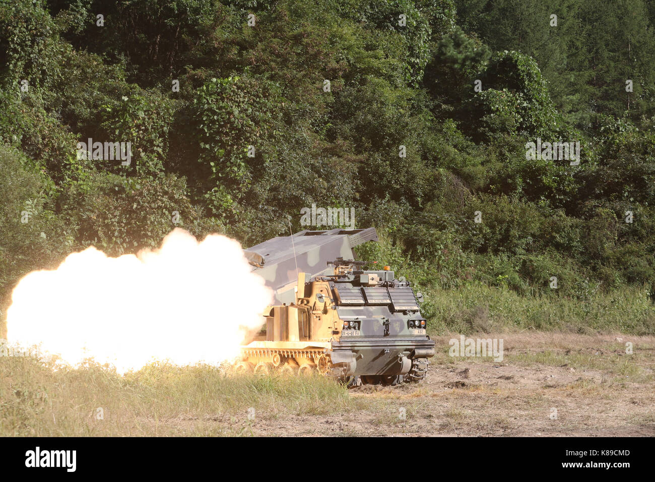 M270 multiple launch rocket system fires during a live fire exercise ...