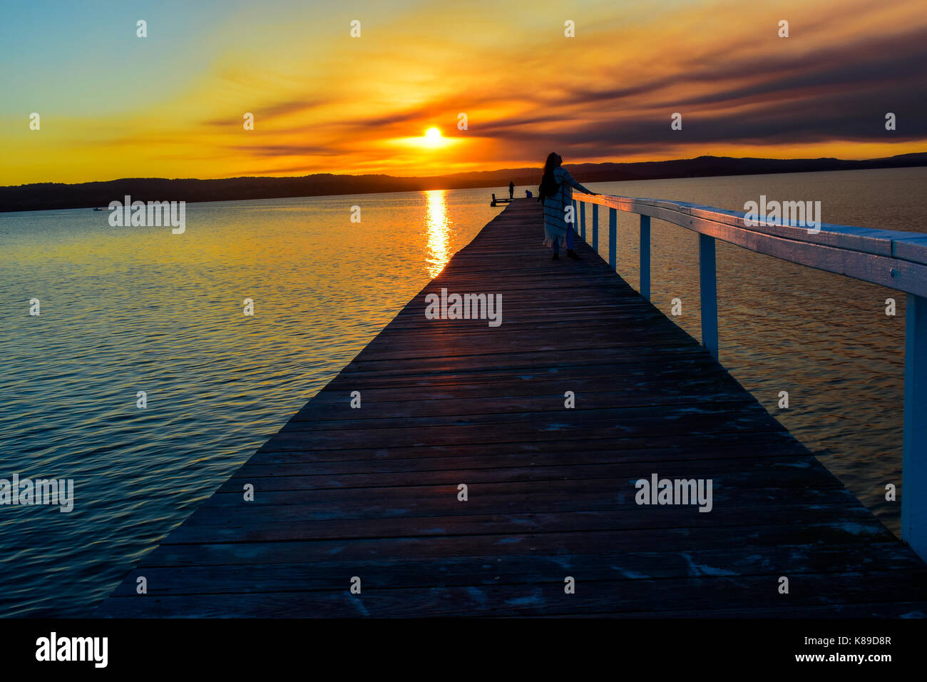 Watching the Sunset on the Long Jetty, NSW Stock Photo - Alamy