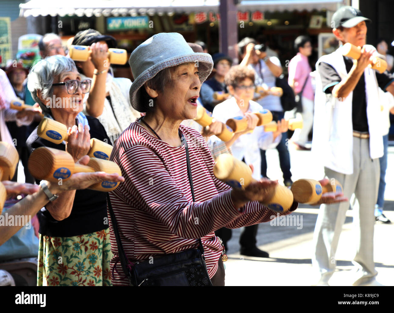 Tokyo, Japan. 18th Sep, 2017. Elderly people work out with wooden ...