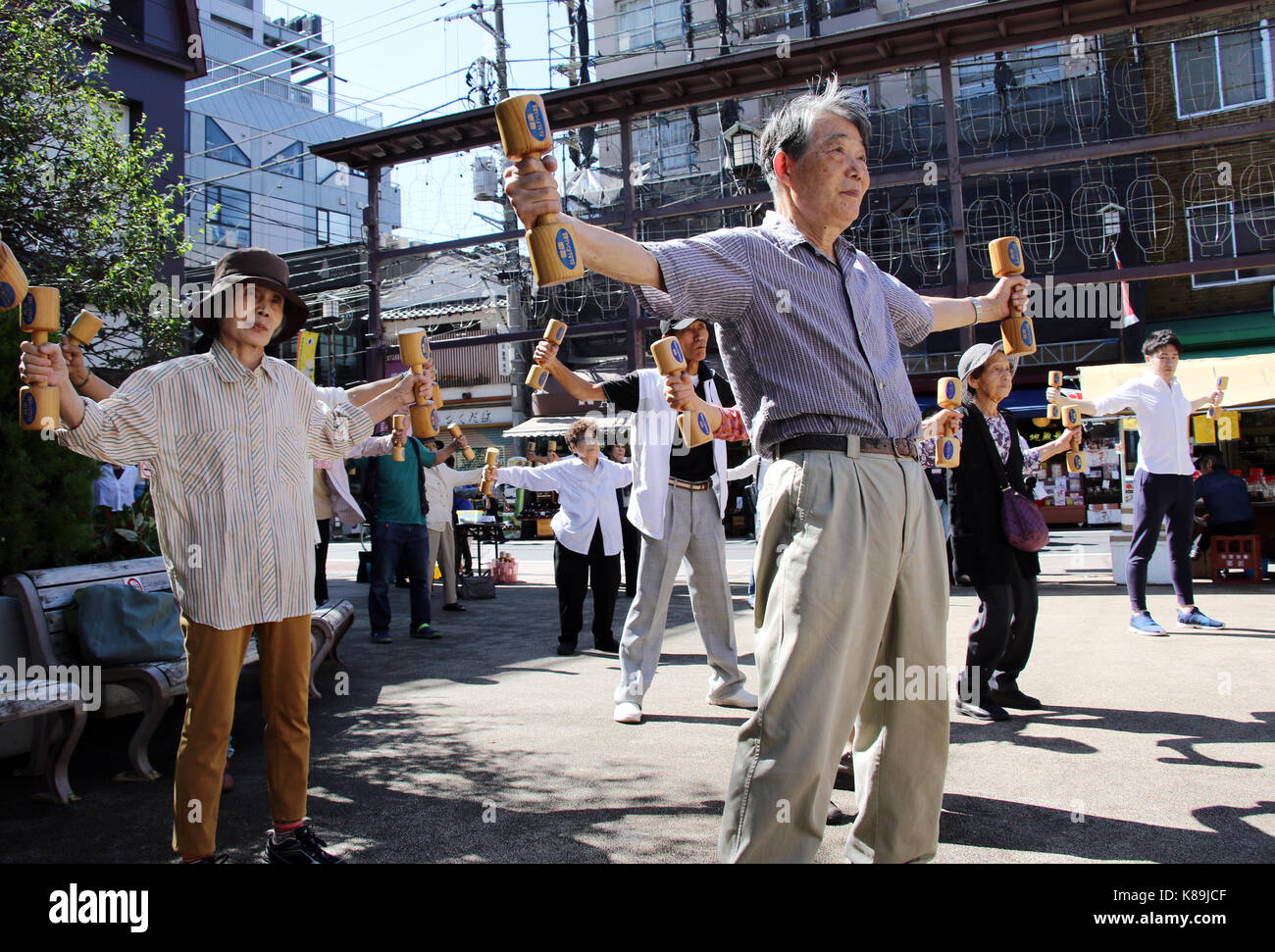 Tokyo, Japan. 18th Sep, 2017. Elderly people work out with wooden ...