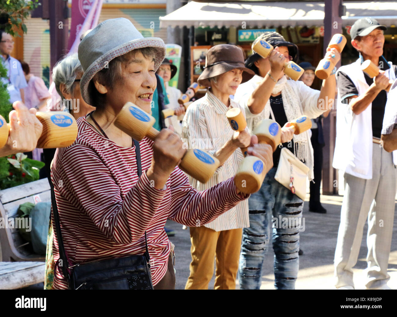 Tokyo, Japan. 18th Sep, 2017. Elderly people work out with wooden ...