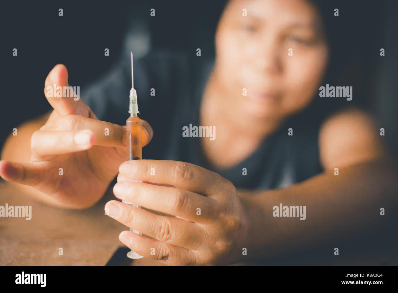 Bad woman. Addict lady with syringe using drugs Stock Photo - Alamy