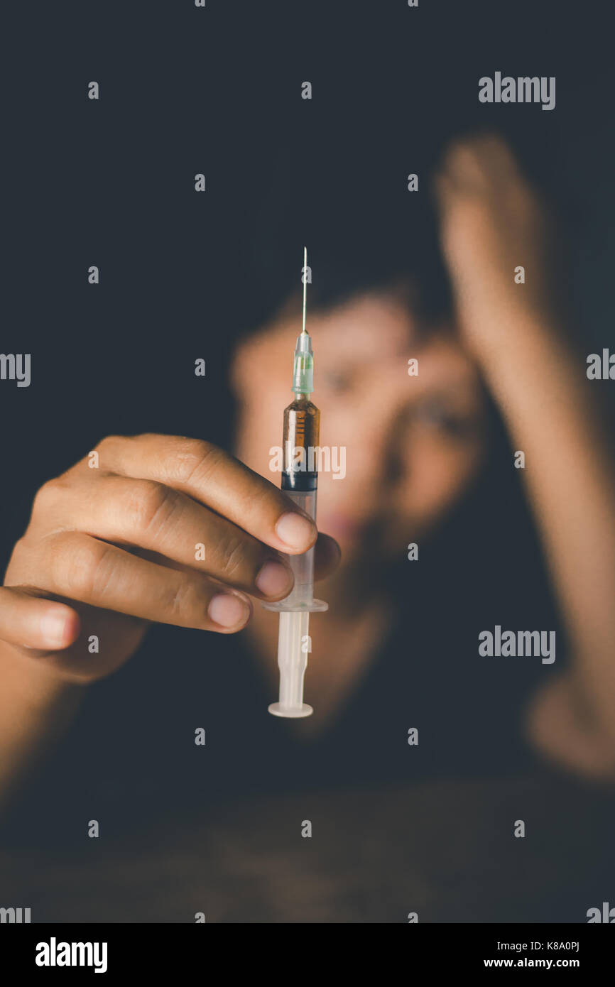 Bad woman. Addict lady with syringe using drugs Stock Photo - Alamy