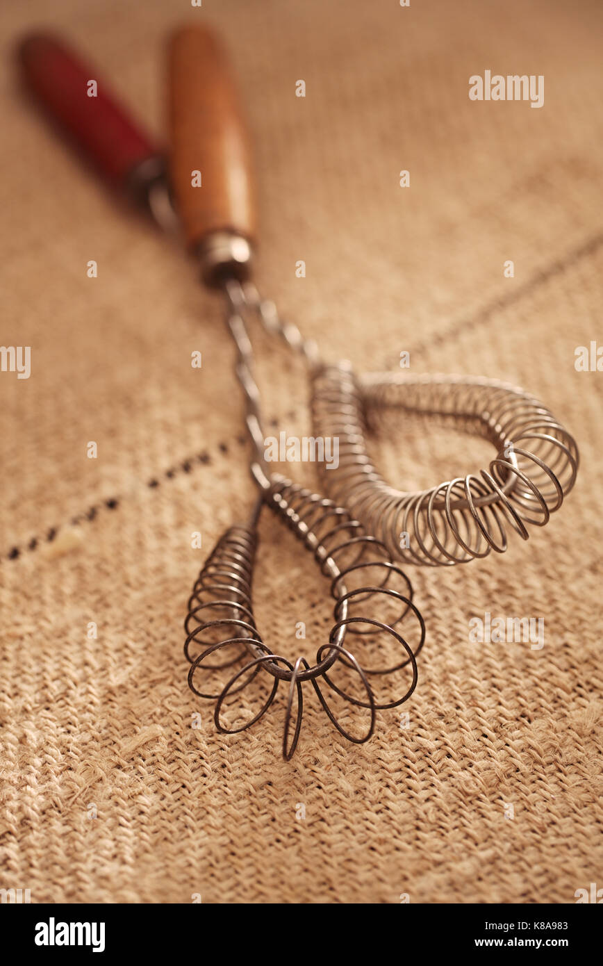 real vintage wooden wire whisk on old grain sacking linen Completely ...