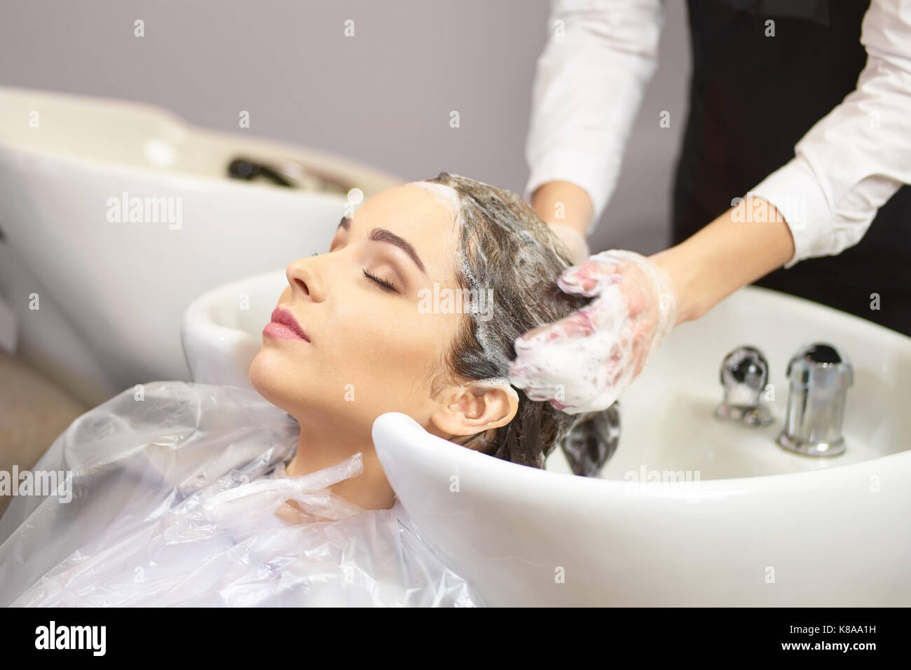 Lady getting her head washed Stock Photo - Alamy