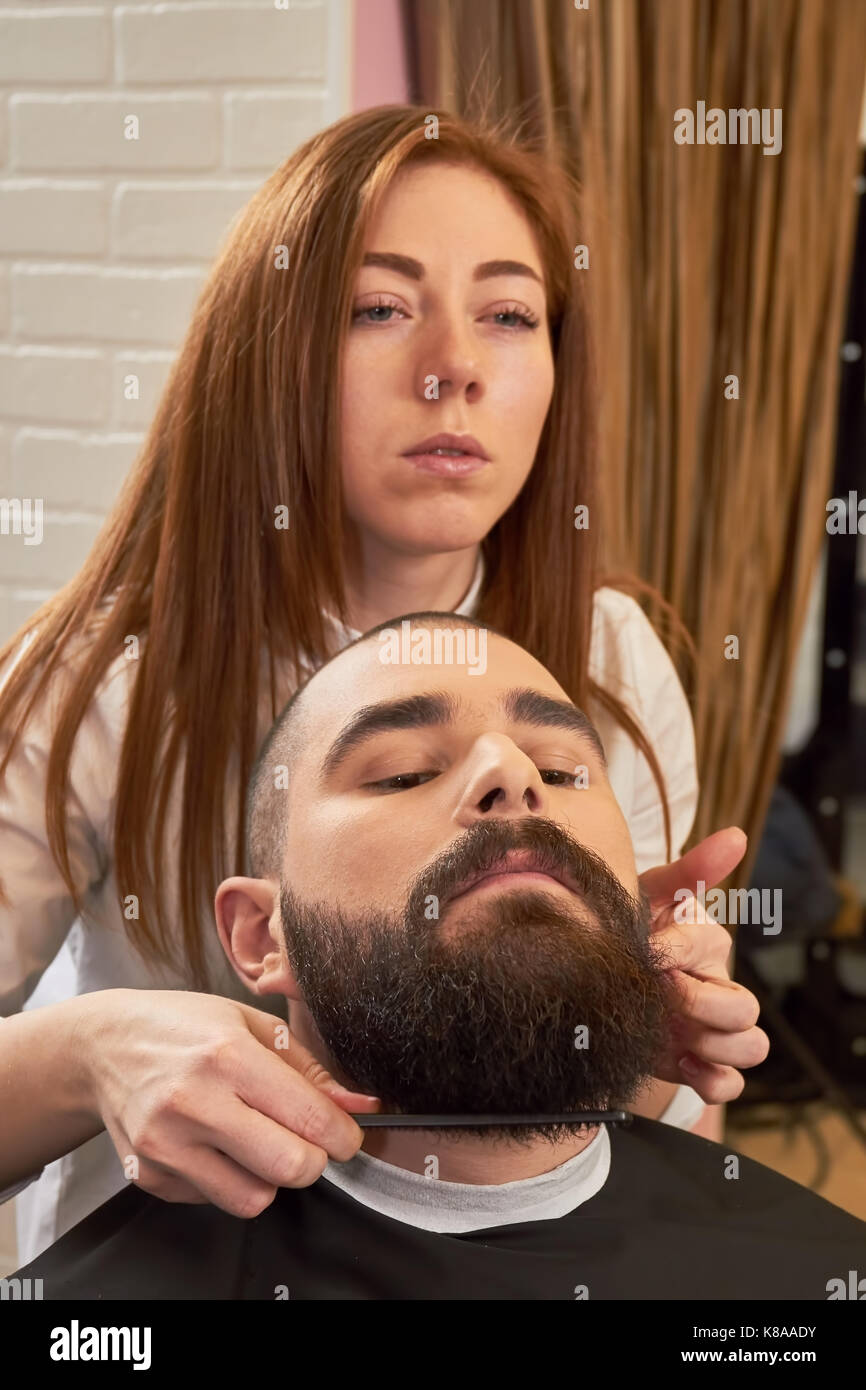 Female barber working with customer Stock Photo - Alamy