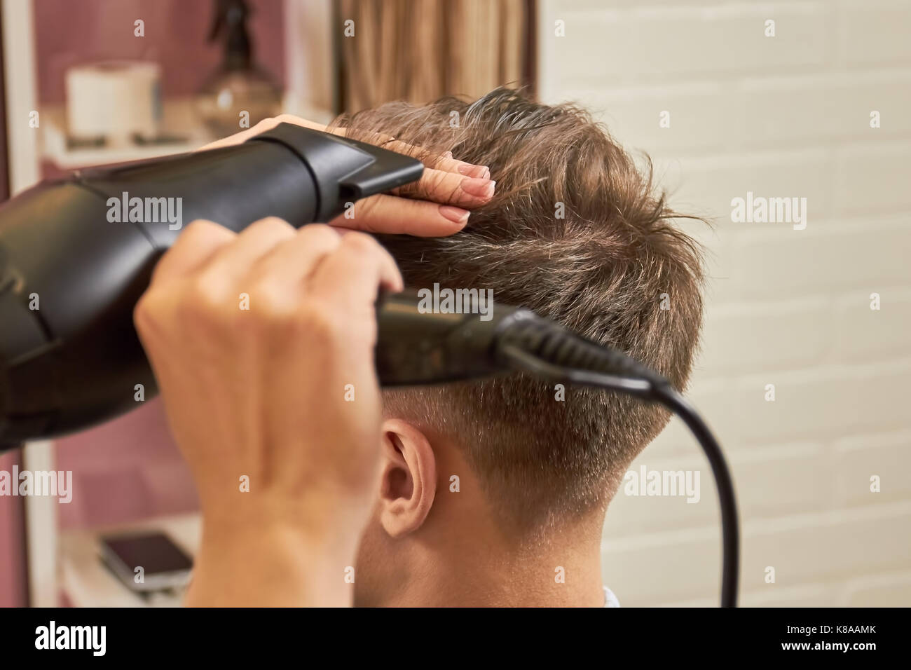 Barber drying hair close up Stock Photo - Alamy