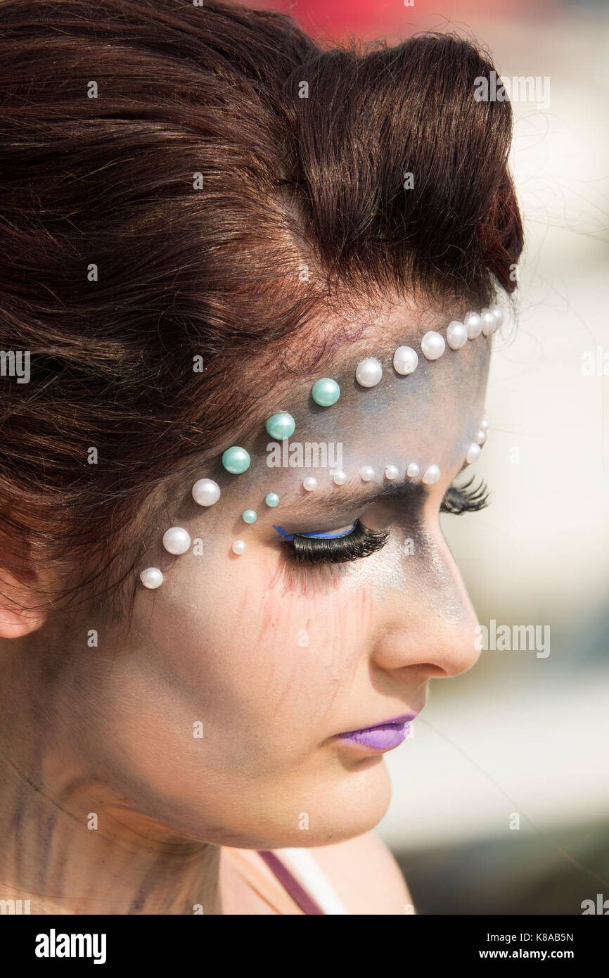 Colorful and beautiful young woman model posing as a human manikin ...