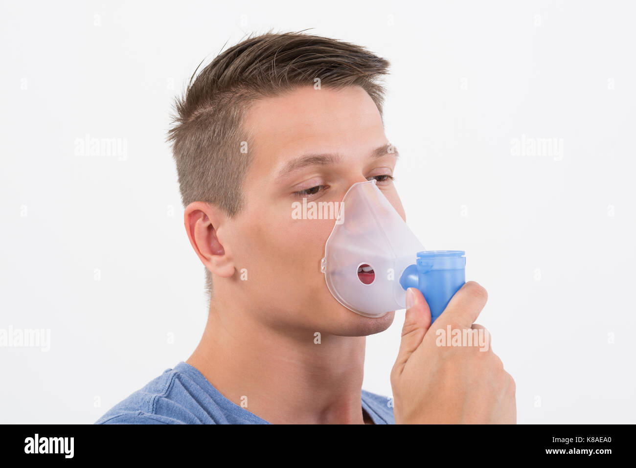 Portrait Of Young Man Inhaling Through Inhaler Mask Stock Photo - Alamy
