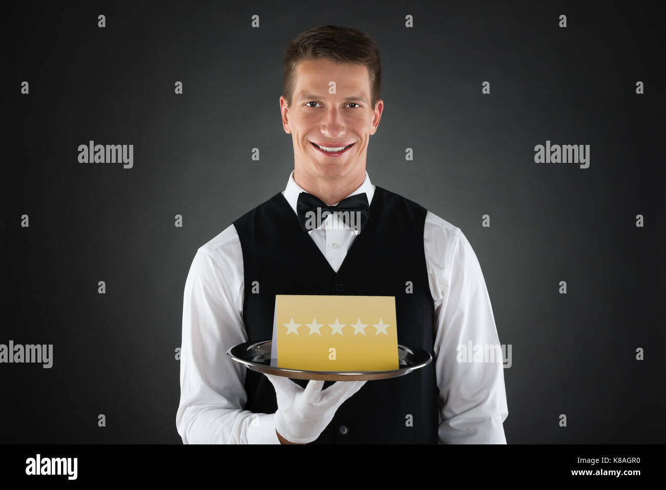 Portrait Of Happy Waiter Holding Plate With Star Rating Board Stock ...