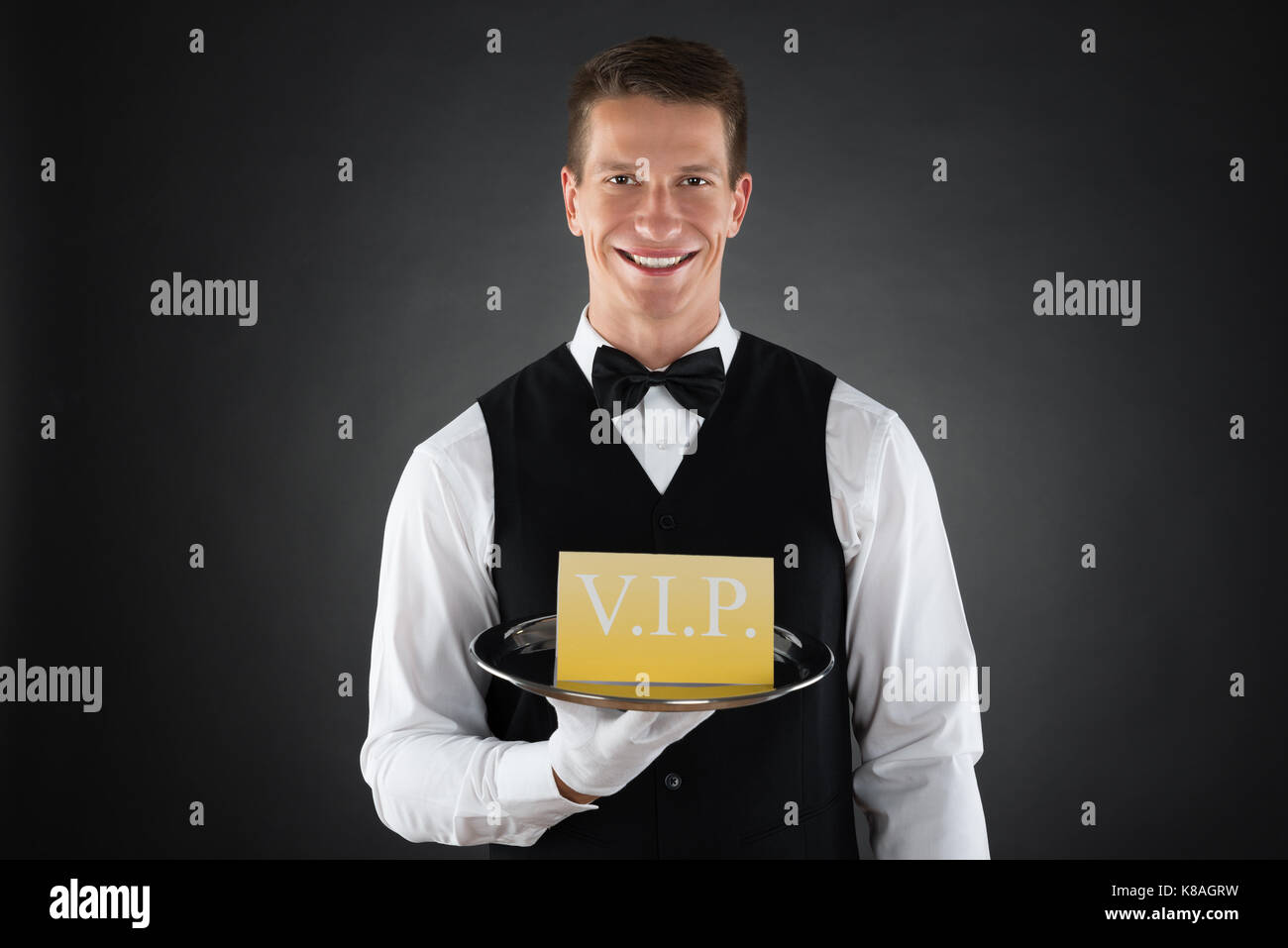 Young Happy Waiter Showing Vip Sign On Tray Stock Photo - Alamy