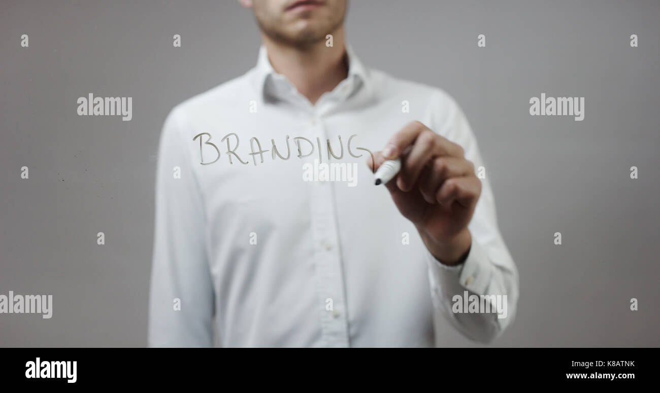 Branding, Man Writing on Glass Stock Photo - Alamy