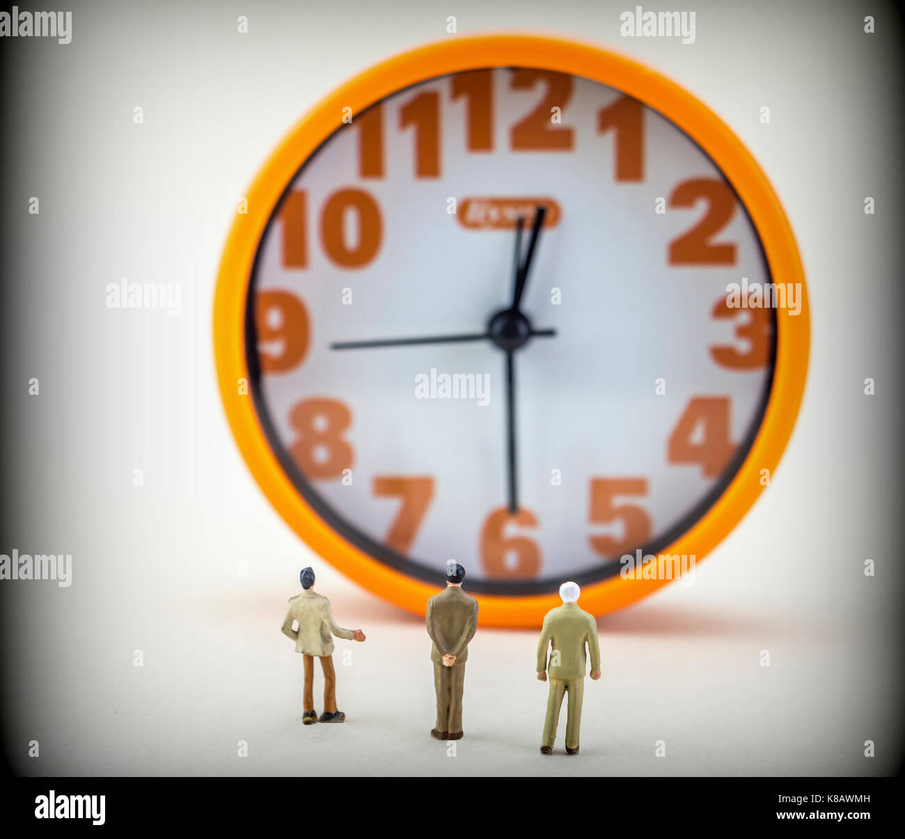 Miniature figures business men front insulated watch on white ...