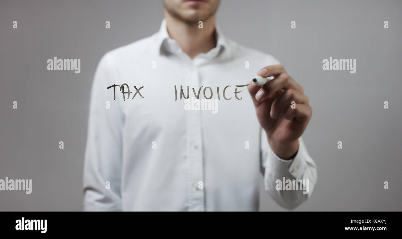 Tax invoice , Man Writing on Glass Stock Photo - Alamy