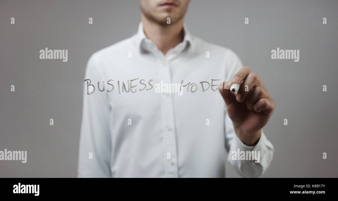 Business model, Man Writing on Glass Stock Photo - Alamy