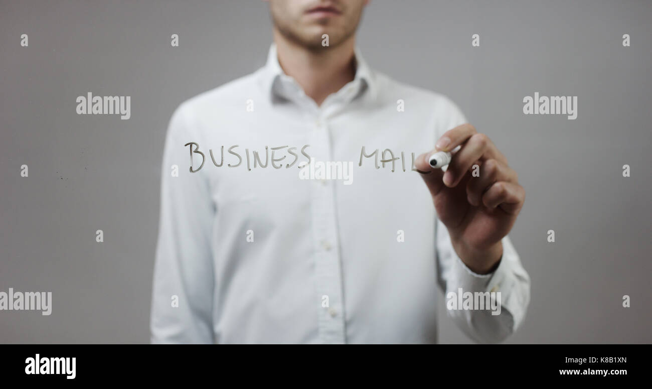 Business mail, Man Writing on Glass Stock Photo - Alamy