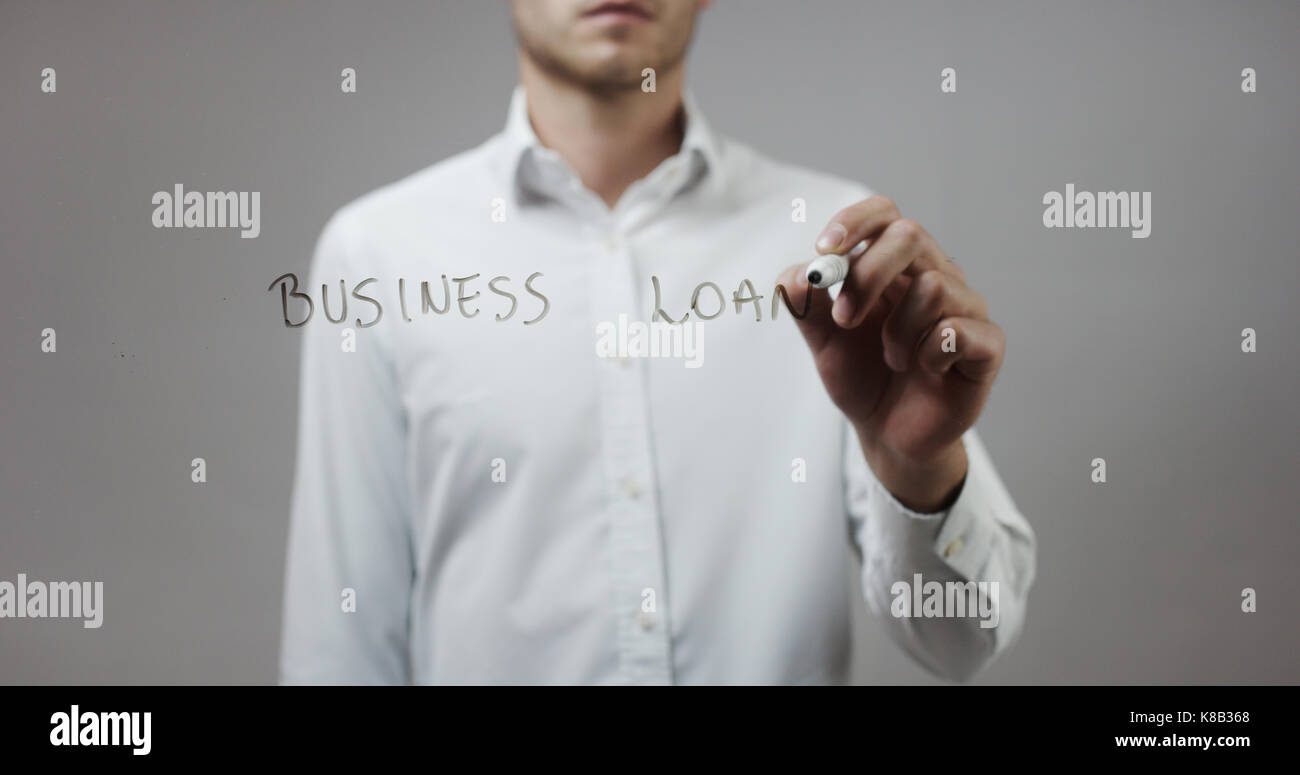 Business loan, Man Writing on Glass Stock Photo - Alamy