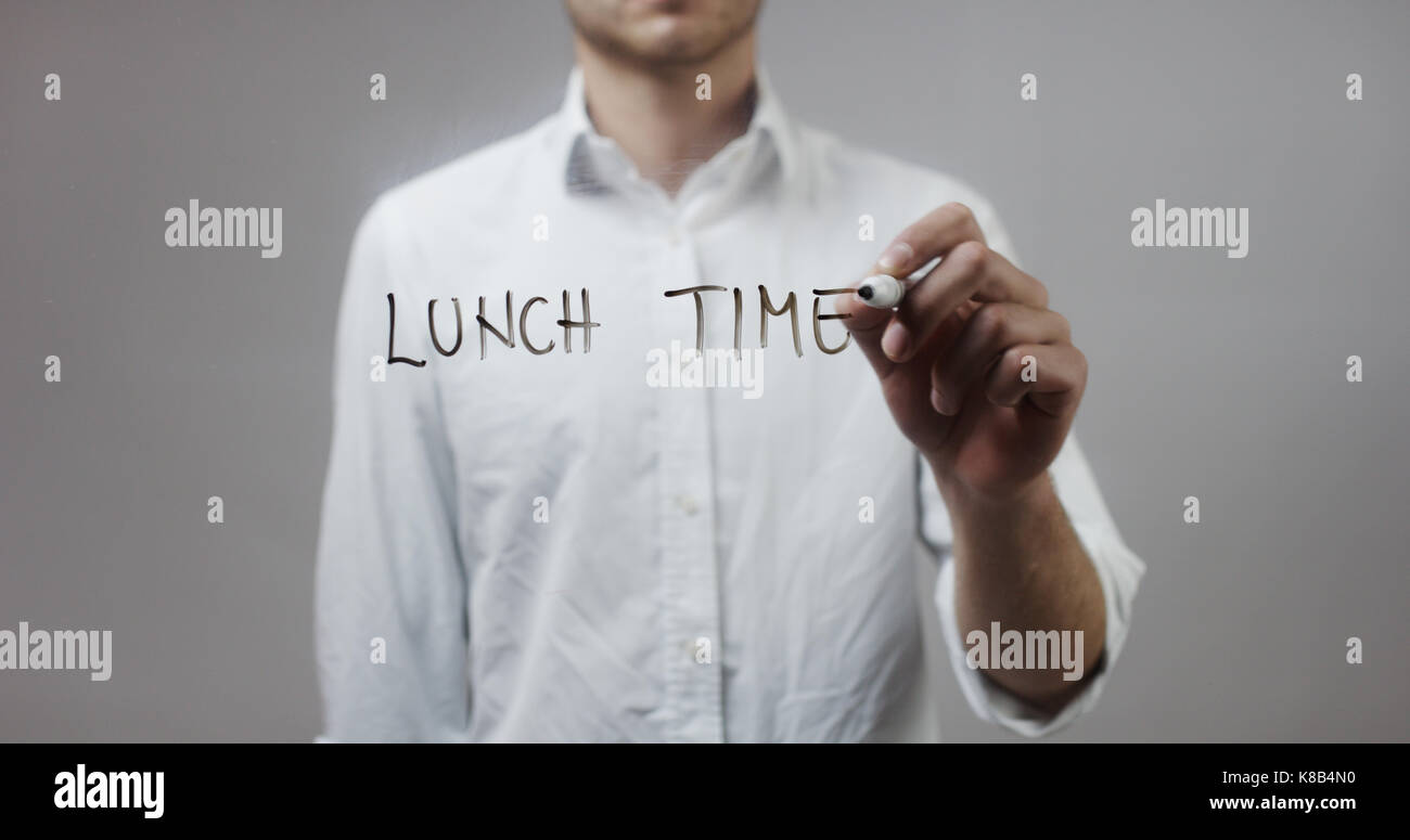 Lunch time , Man Writing on Glass Stock Photo - Alamy