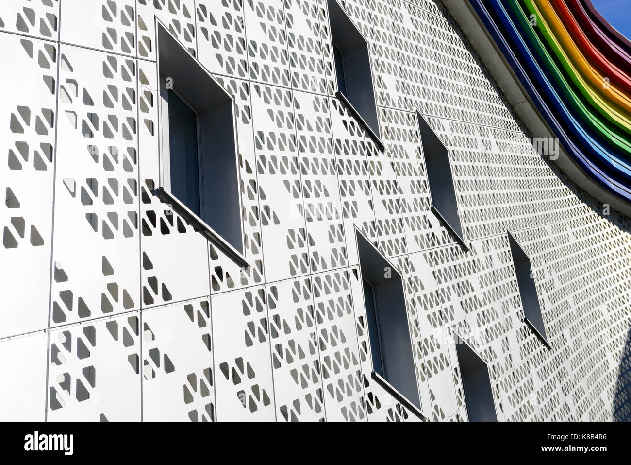 Building with metal trim and multi-colored roof Stock Photo - Alamy