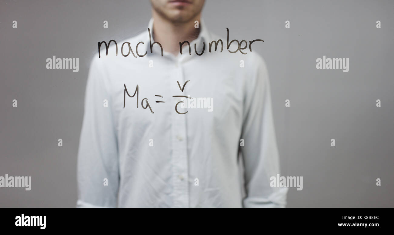 Mach number , Man Writing on Glass Stock Photo - Alamy