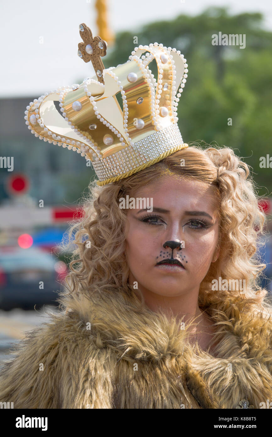 Colorful and beautiful young woman model posing as a human manikin ...