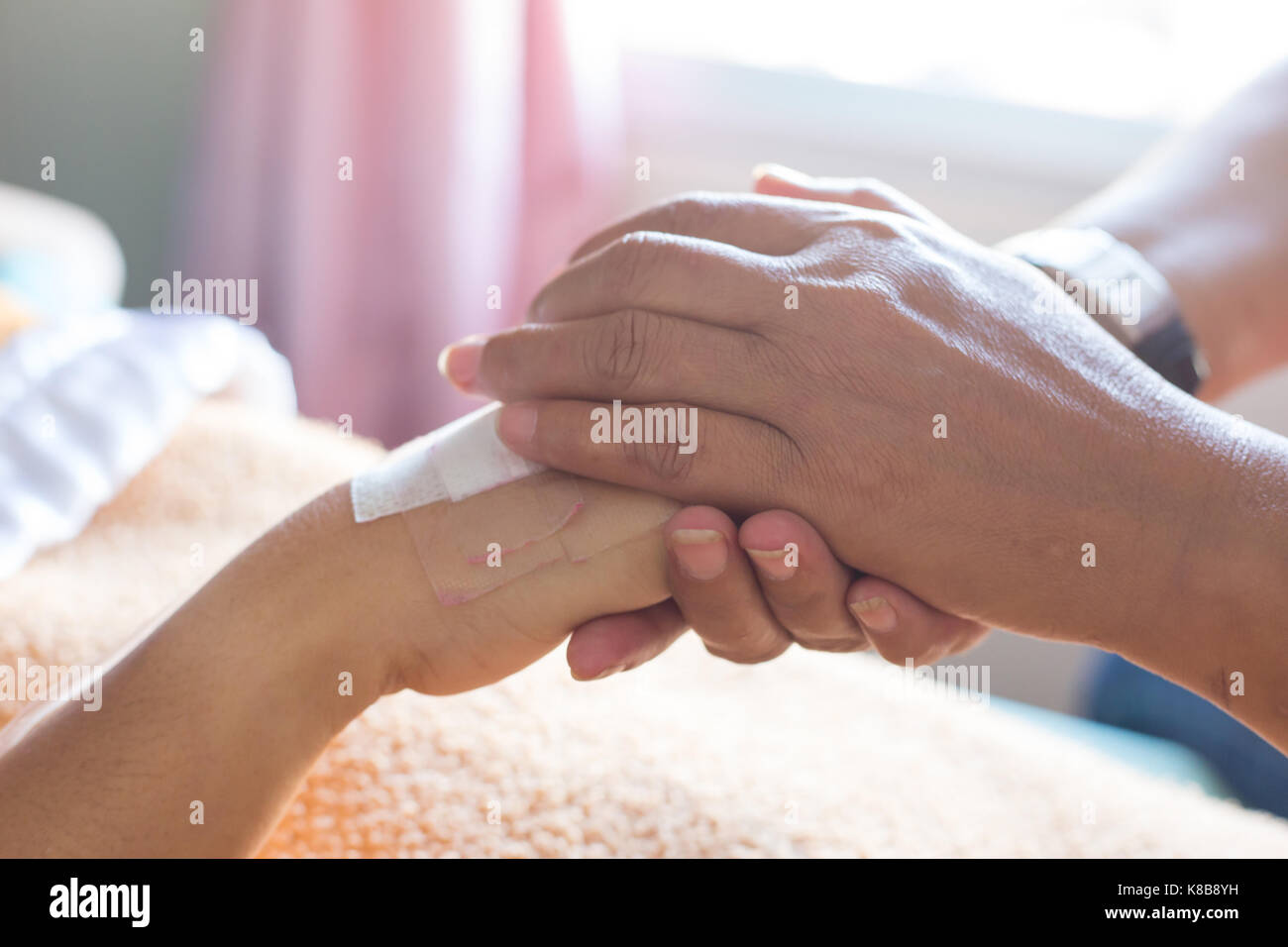 Hand of Family reassuring female patient Stock Photo - Alamy