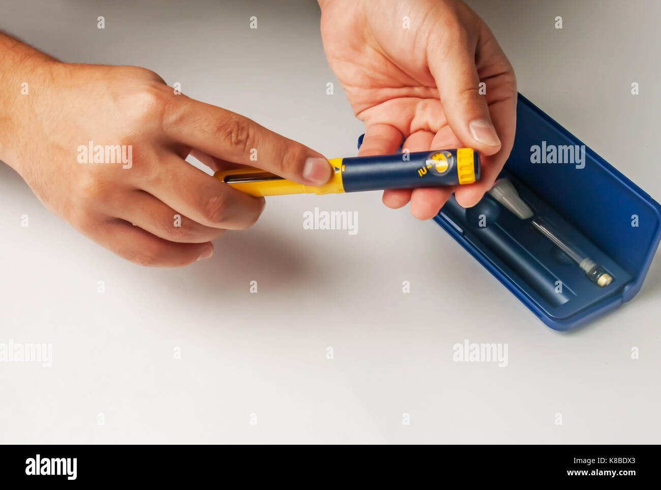 A man holds a syringe for subcutaneous injection of hormonal drugs in ...