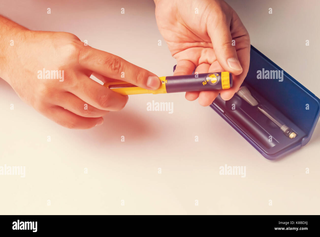 A man holds a syringe for subcutaneous injection of hormonal drugs in ...