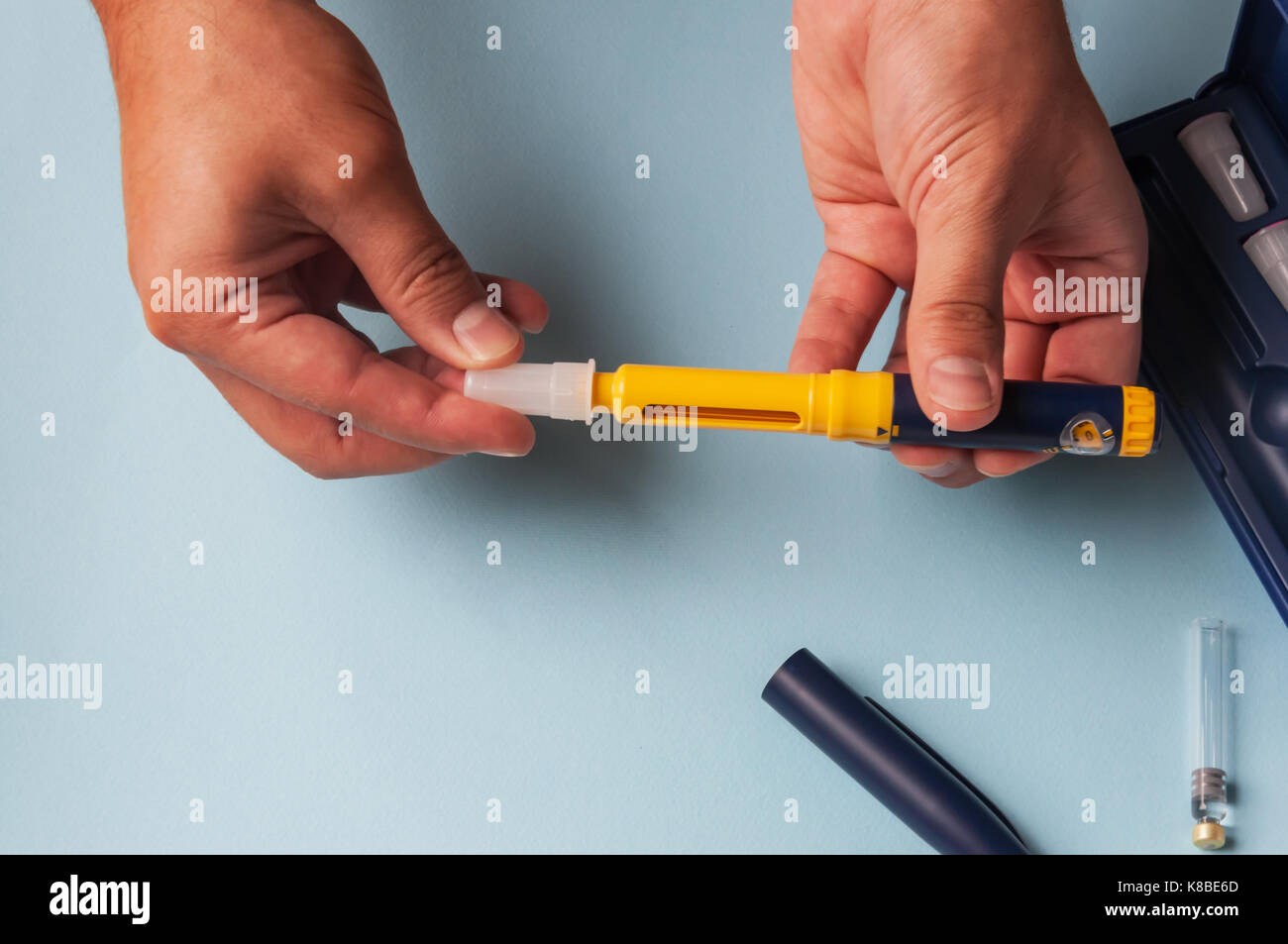 A man holds a syringe for subcutaneous injection of hormonal drugs in ...