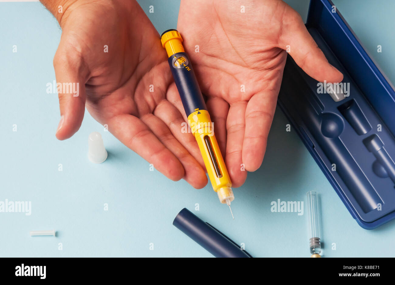 A man holds a syringe for subcutaneous injection of hormonal drugs in ...