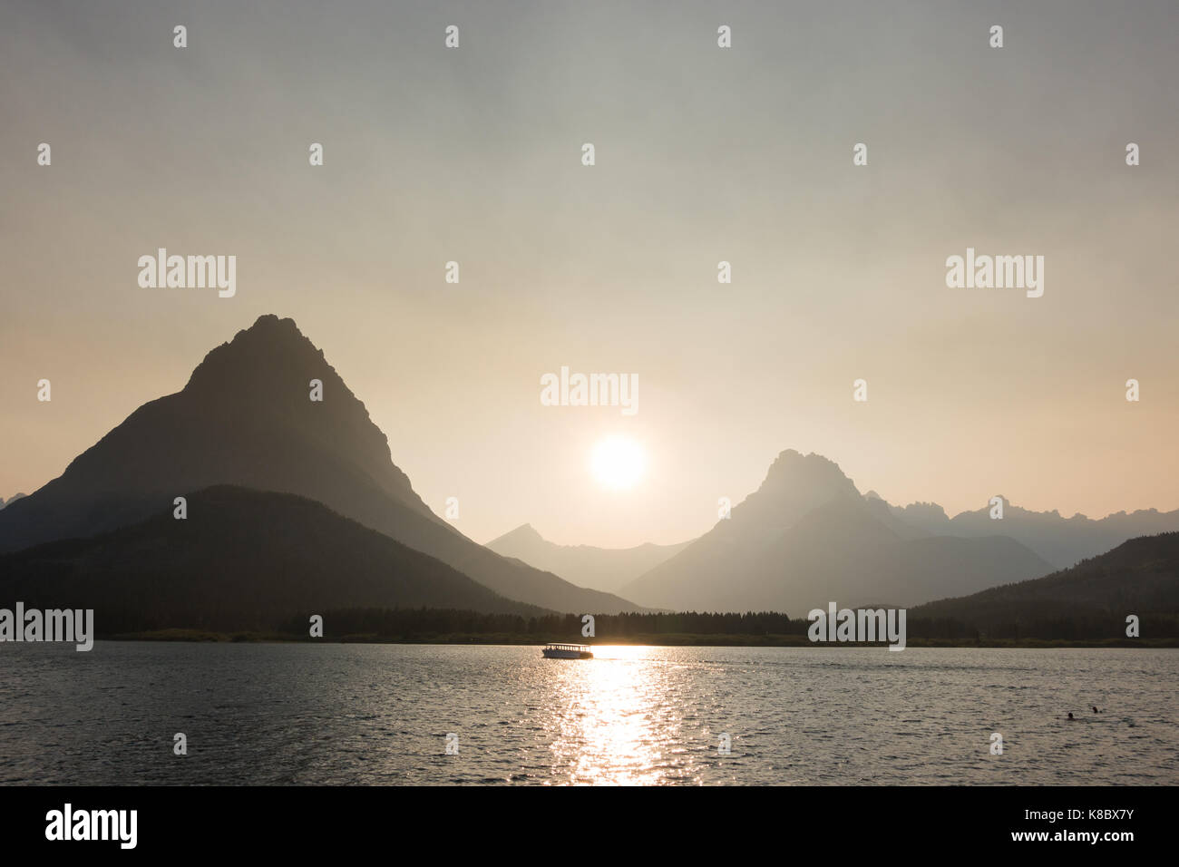 Historic wooden boat on the Swiftcurrent Lake in the Glacier National ...