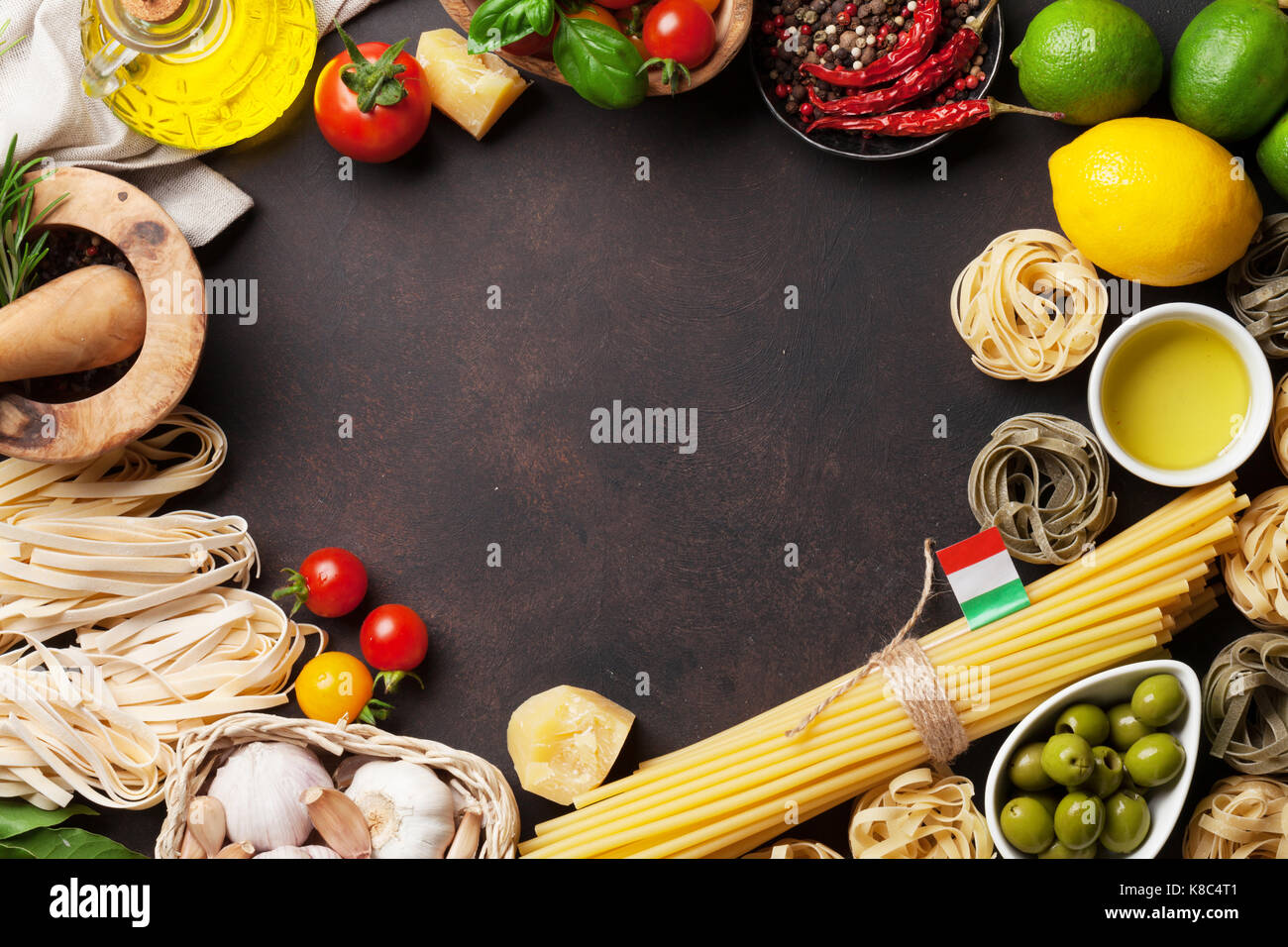 Italian food. Pasta ingredients on stone table. Top view with space for ...