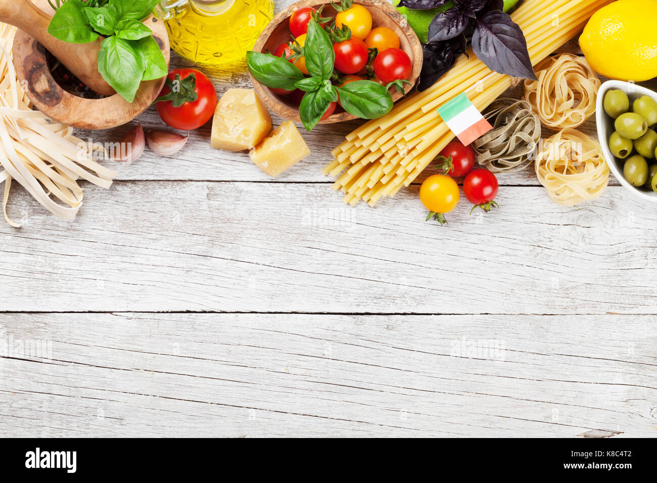 Italian food. Pasta ingredients on wooden table. Top view with space ...