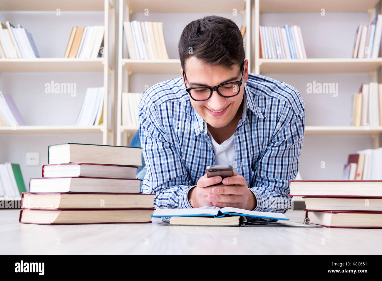 Young student studying with books Stock Photo - Alamy