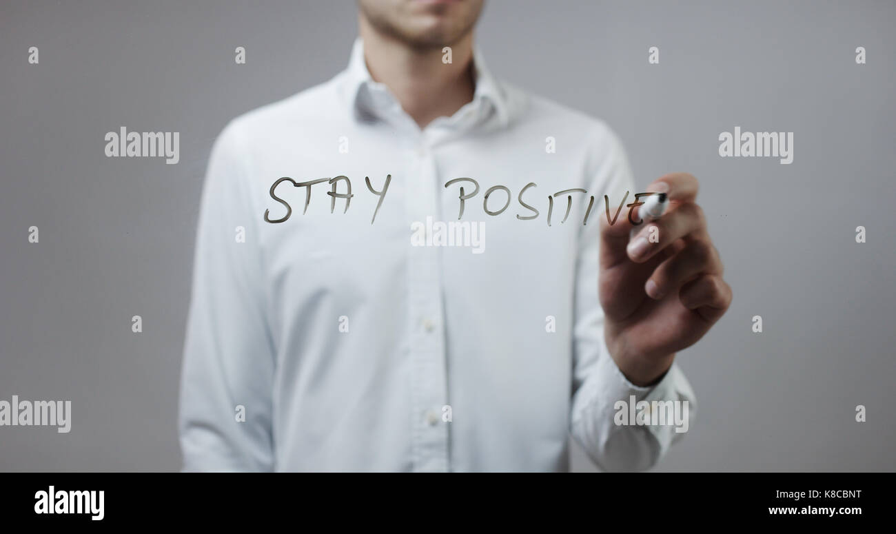 Stay positive , Man Writing on Glass Stock Photo - Alamy