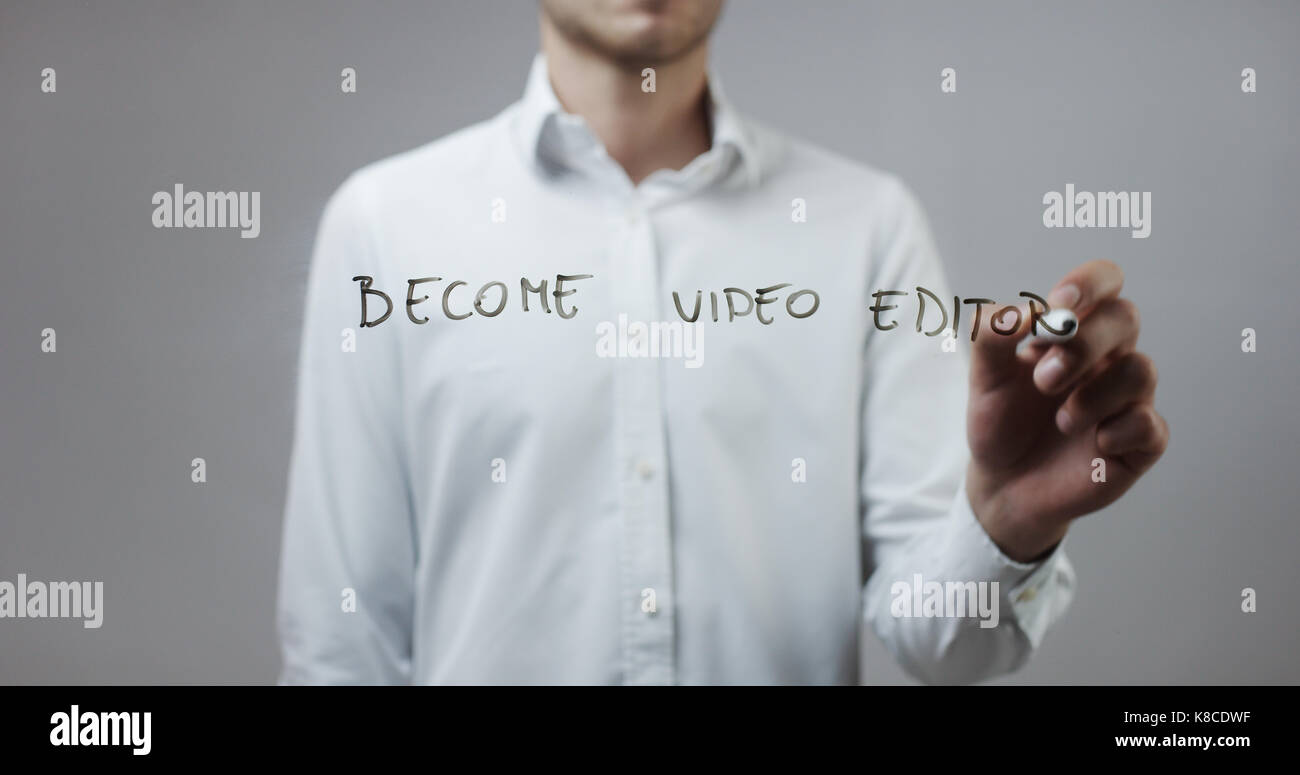 Become video editor , Man Writing on Glass Stock Photo - Alamy