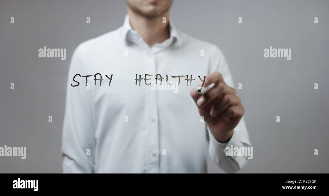 Stay healthy , Man Writing on Glass Stock Photo - Alamy