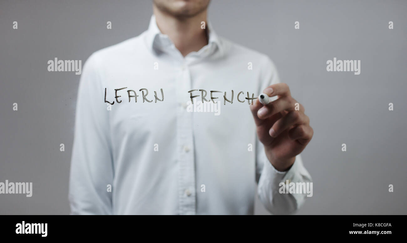 Learn French , Man Writing on Glass Stock Photo - Alamy