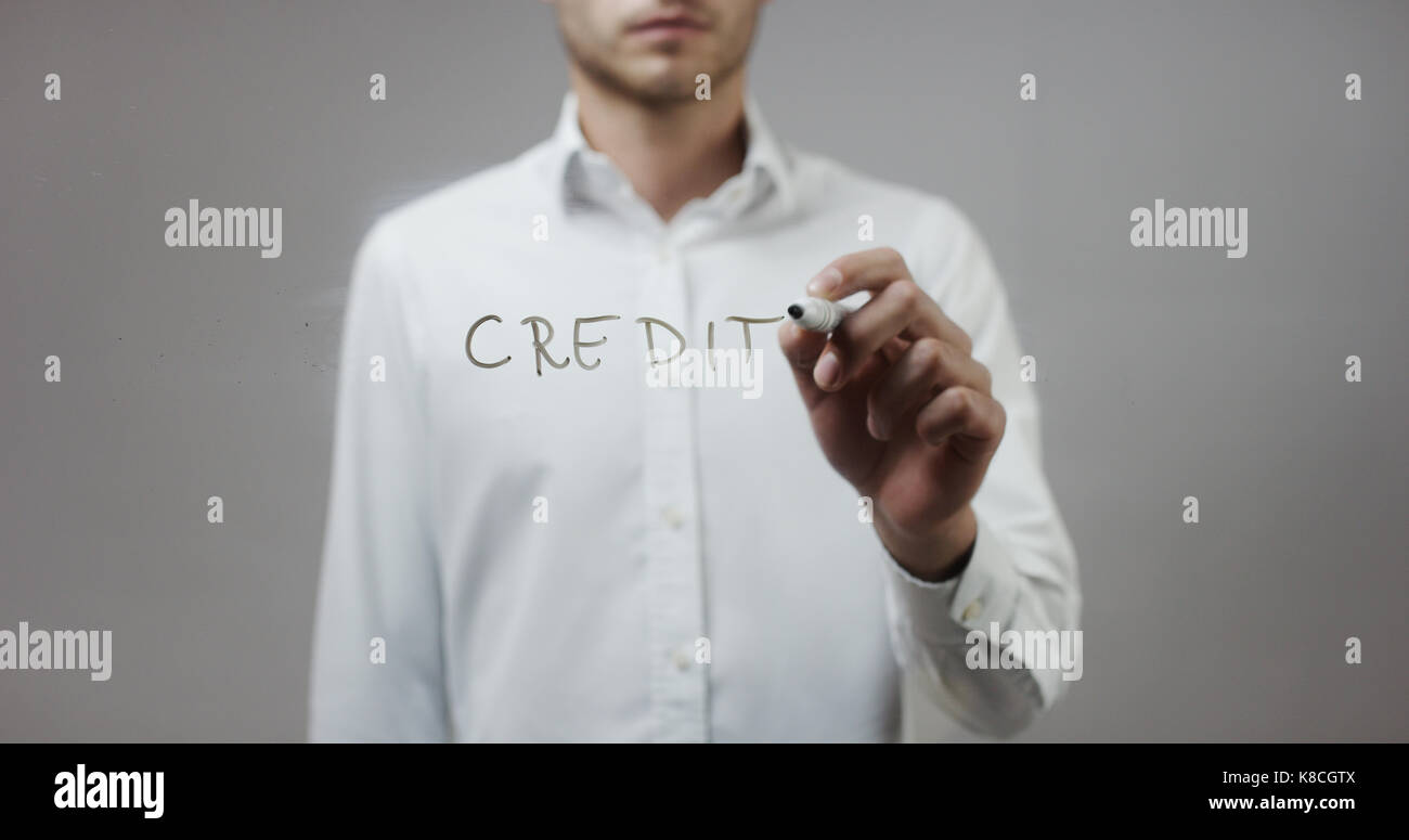 Credit, Man Writing on Glass Stock Photo - Alamy