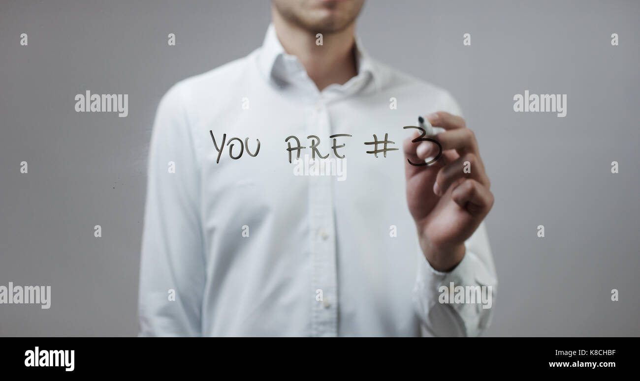 You are #3 , Man Writing on Glass Stock Photo - Alamy
