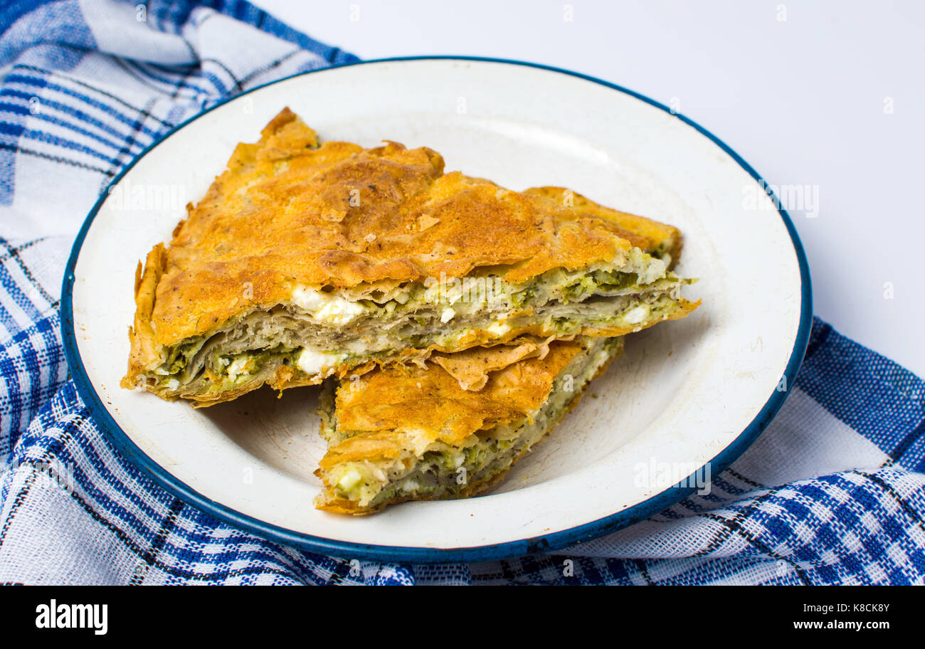 Homemade triangle pie slice with cheese and spinach Stock Photo - Alamy