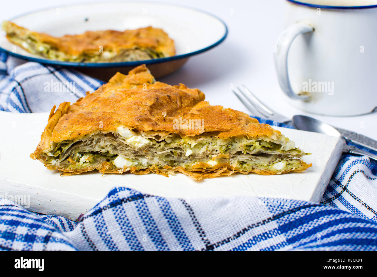Homemade triangle pie slice with cheese and spinach Stock Photo - Alamy