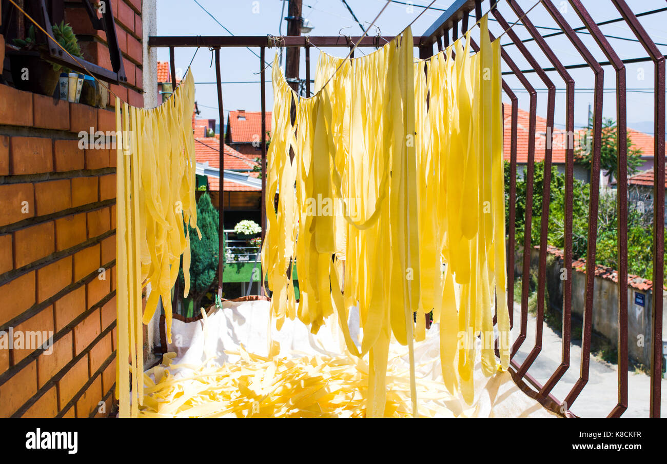 Homemade pastry drying on the sun in the balcony Stock Photo - Alamy