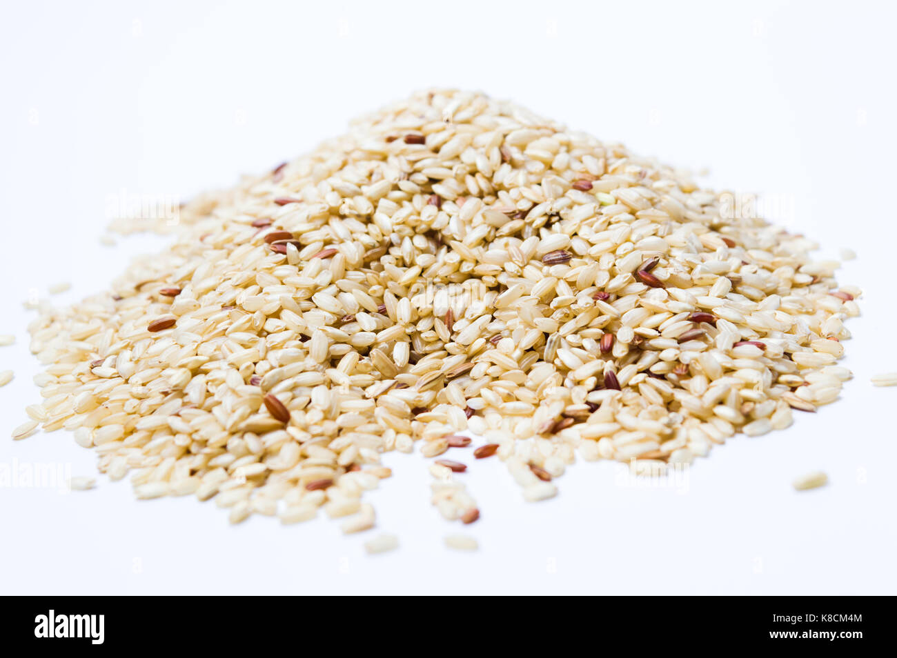 Yellow rice on a pile on white background Stock Photo - Alamy
