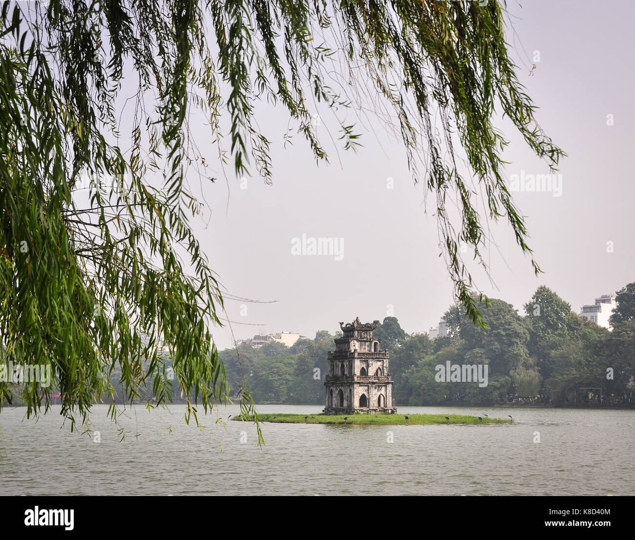 Turtle tower on the Hoan Kiem Lake (Ho Guom) with green trees in Hanoi ...