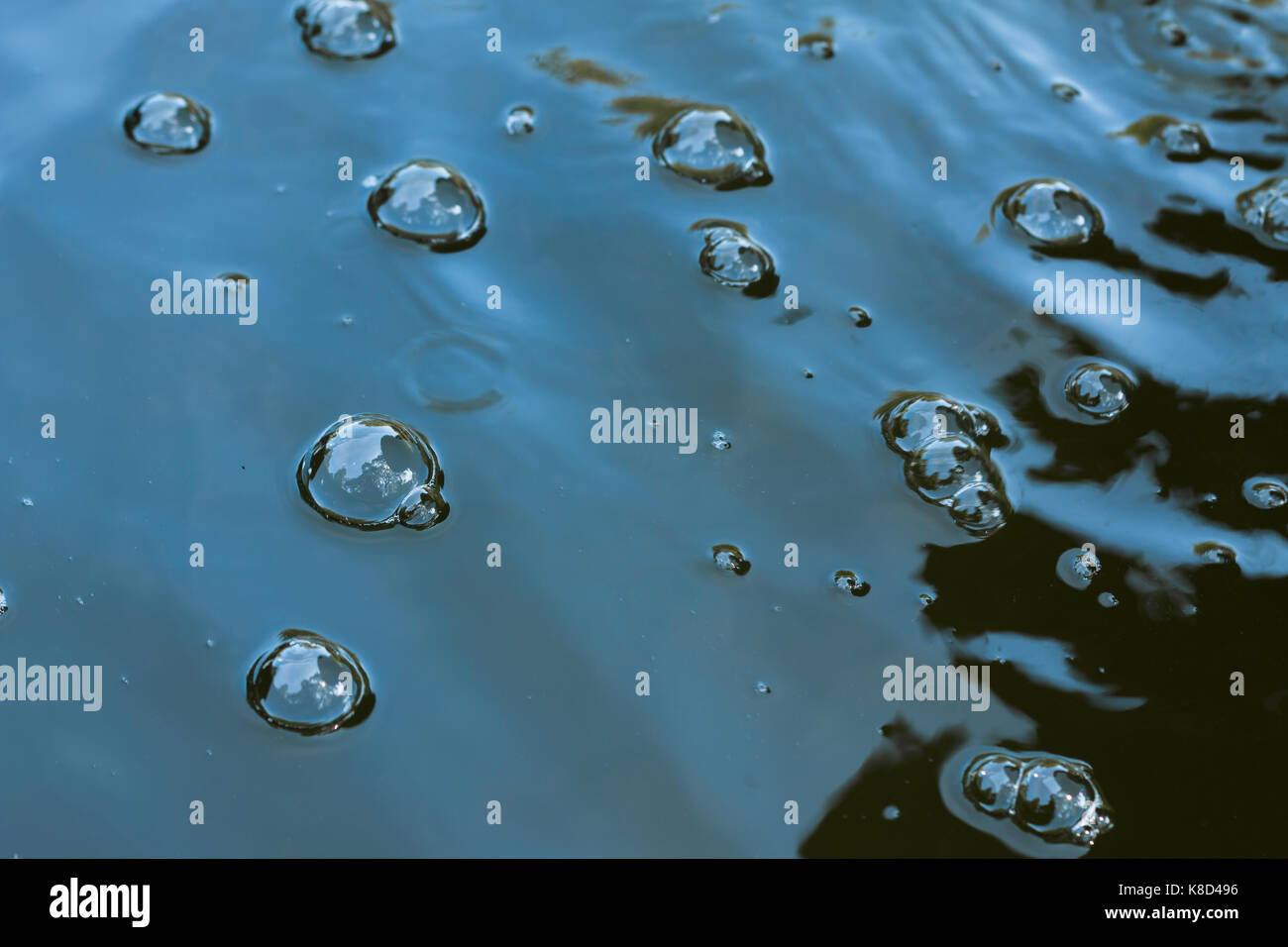 Bubbles floating on surface of water Stock Photo - Alamy